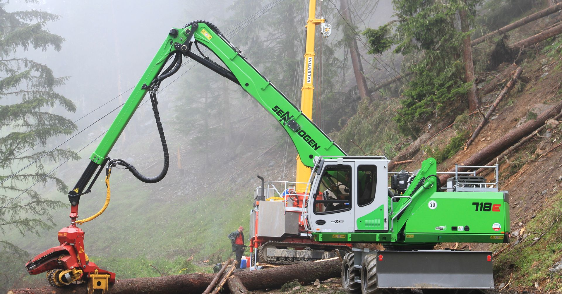 Operating on a steep slope: timber handler in cable yarding operation ...